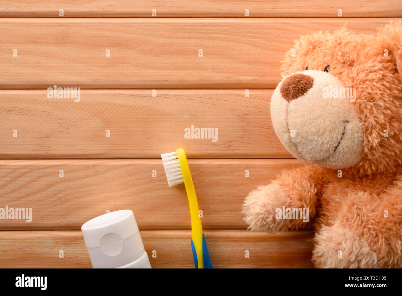 Children's oral hygiene with cleaning elements on wooden table and ...