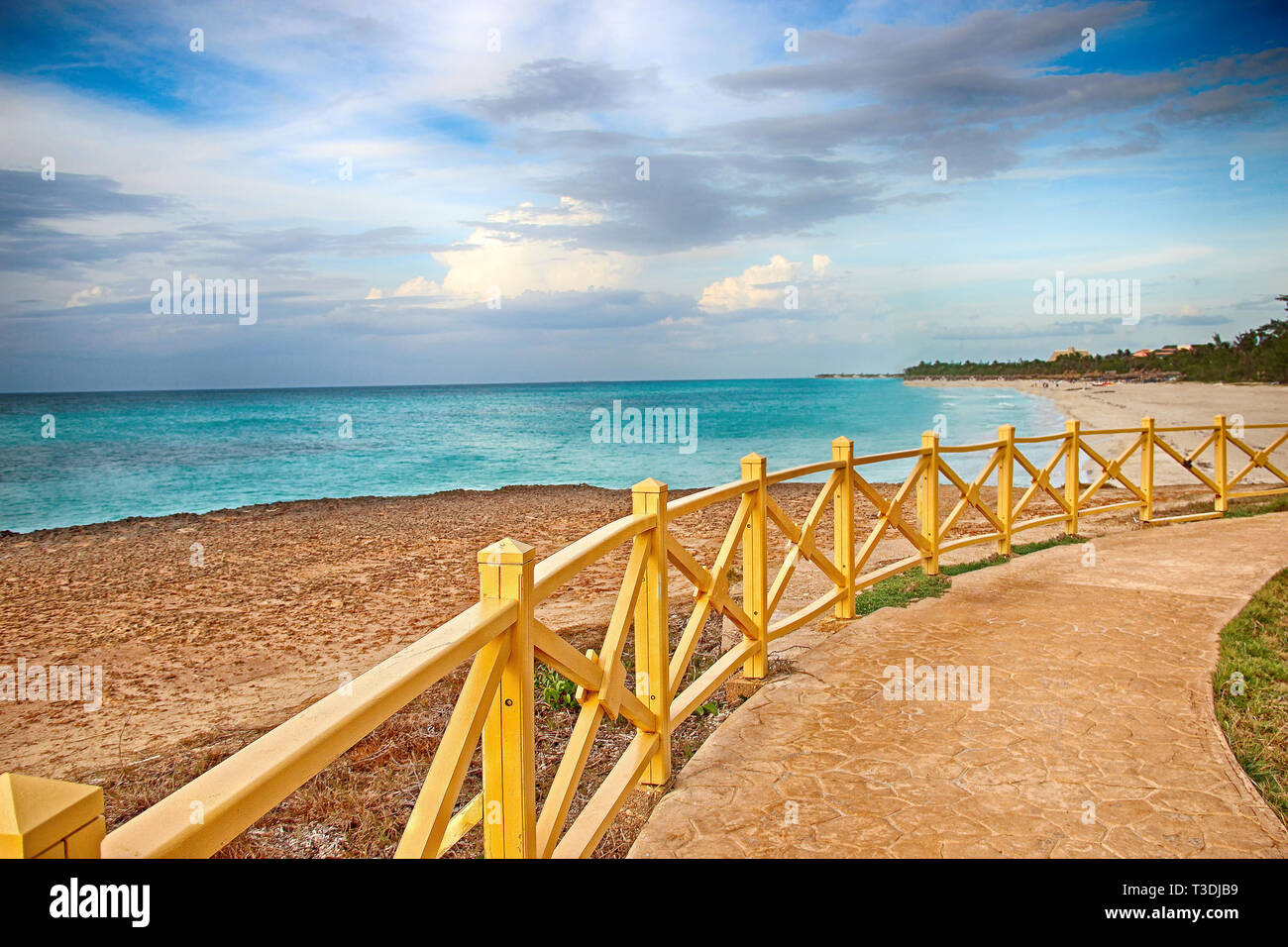 Promenade around the sea with a wooden railing and a view of the water ...
