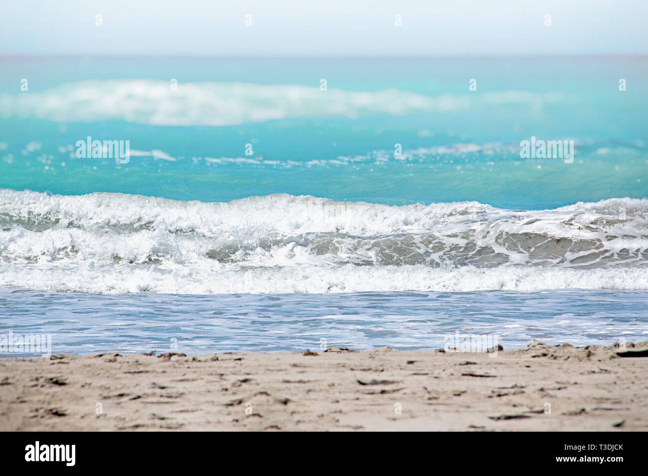 The clear turquoise sea of the Atlantic ocean on which are white waves ...