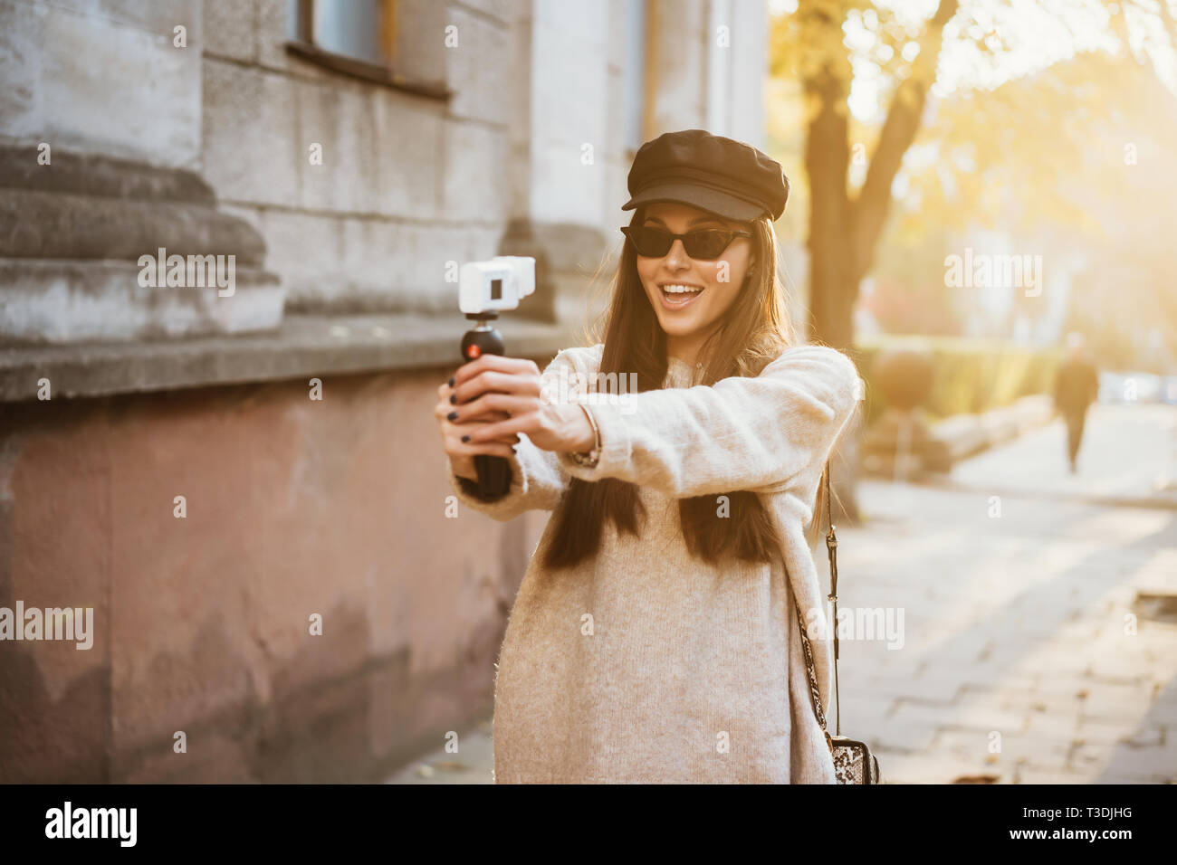 Cute, young female blogger posing on camera Stock Photo - Alamy
