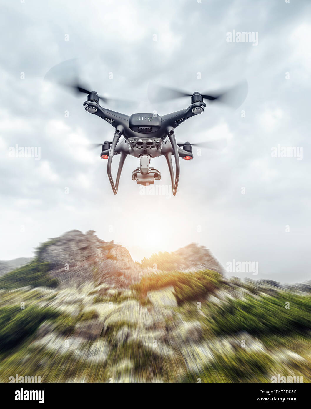 Modern drone flies in the mountains Stock Photo - Alamy
