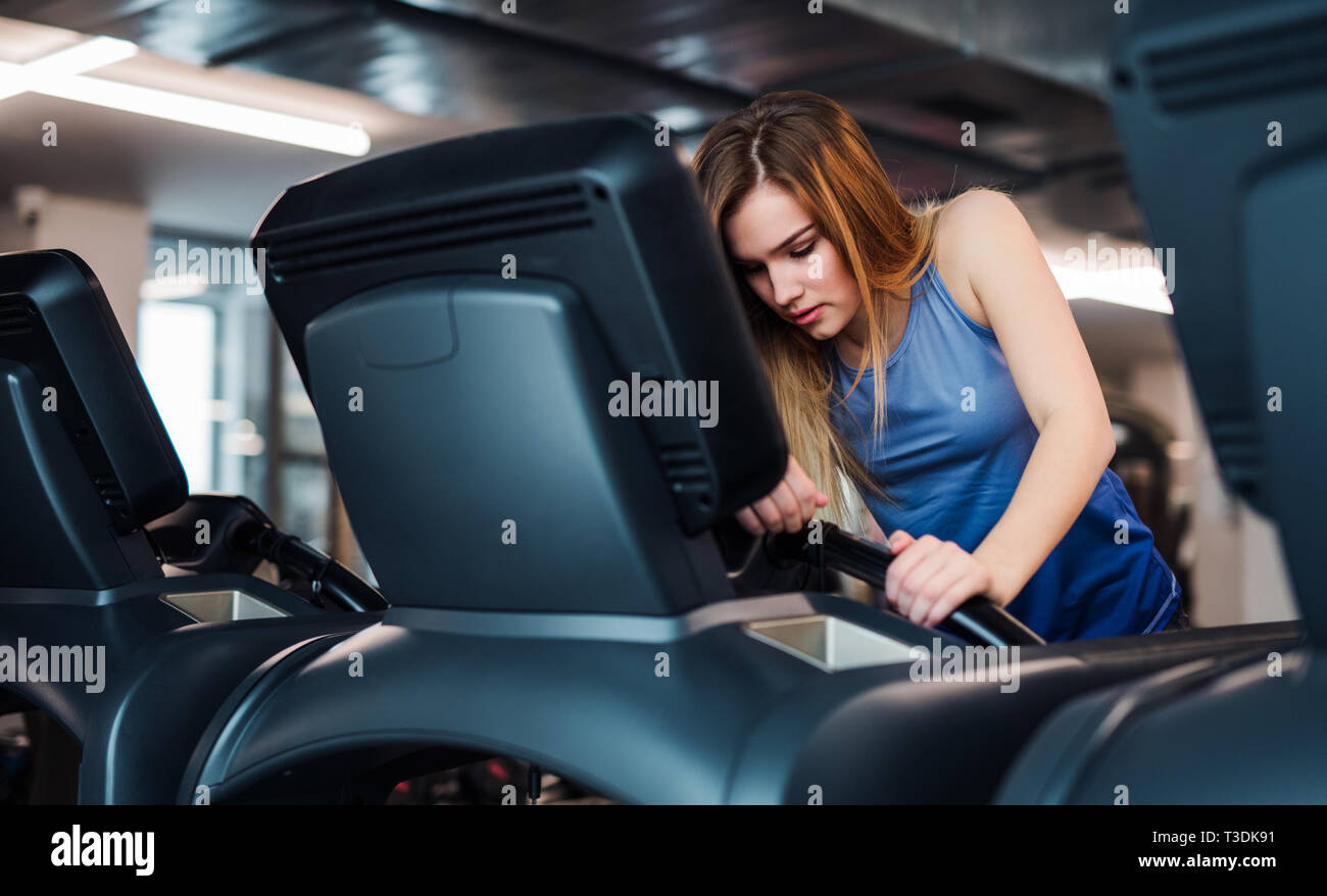 A young girl or woman doing cardio workout in a gym Stock Photo - Alamy