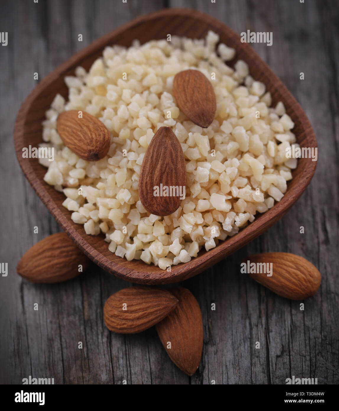 Small pieces of chopped almonds with whole ones in a bowl Stock Photo ...