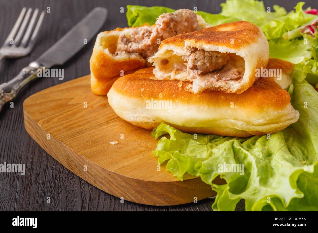 Triangular Russian belyashi with meat Stock Photo - Alamy