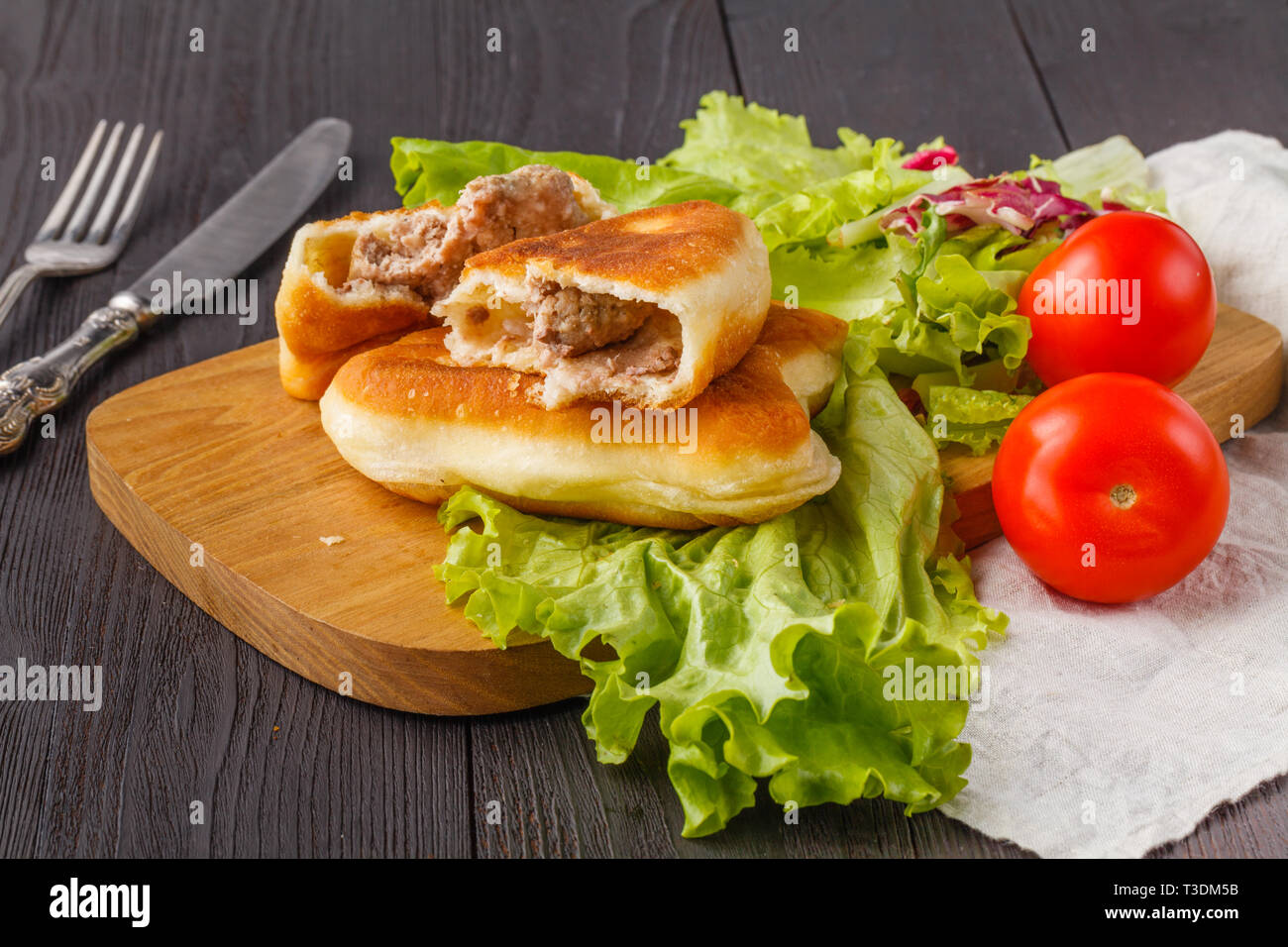 Triangular Russian belyashi with meat Stock Photo - Alamy
