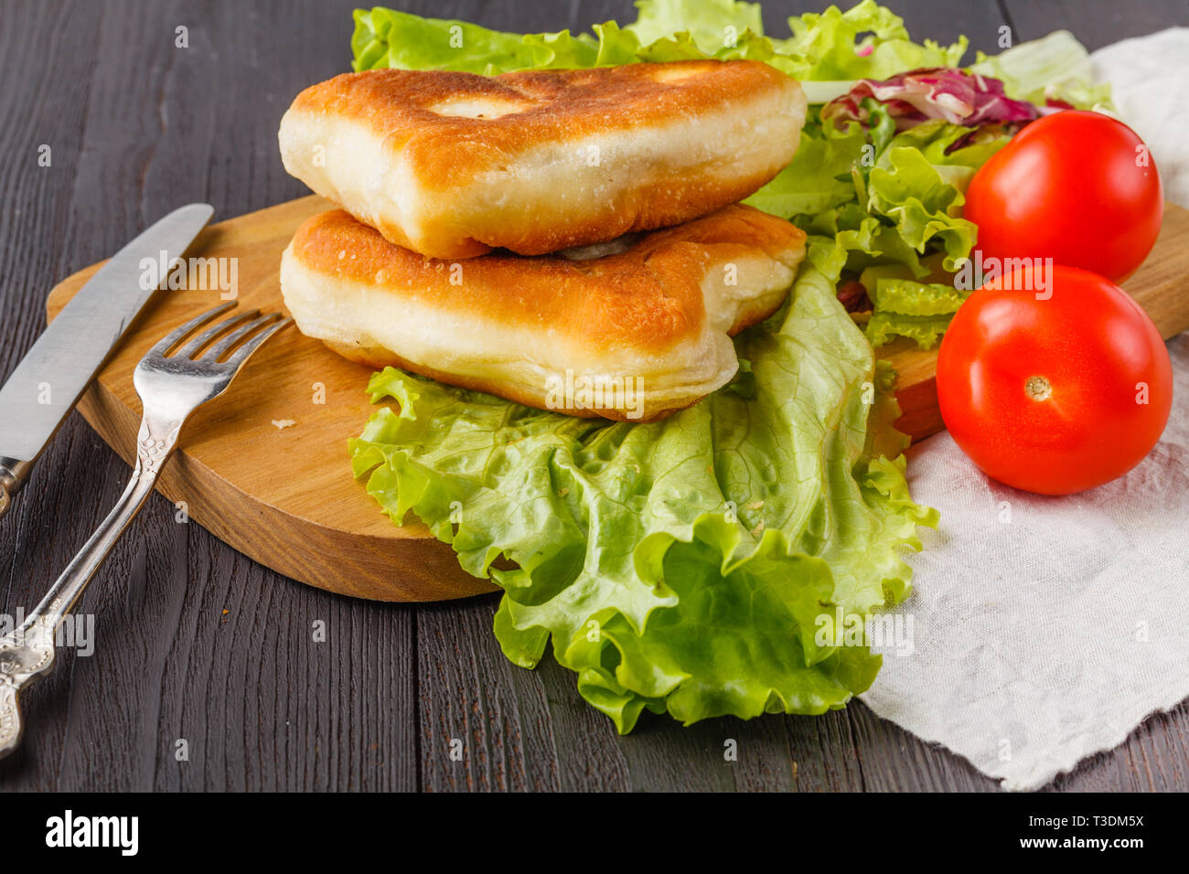 Triangular Russian belyashi with meat Stock Photo - Alamy