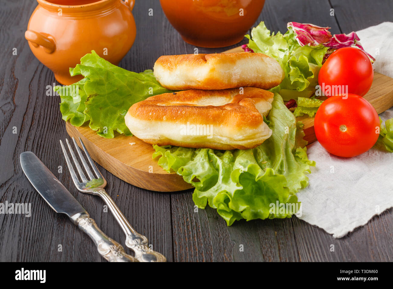 Triangular Russian belyashi with meat Stock Photo - Alamy