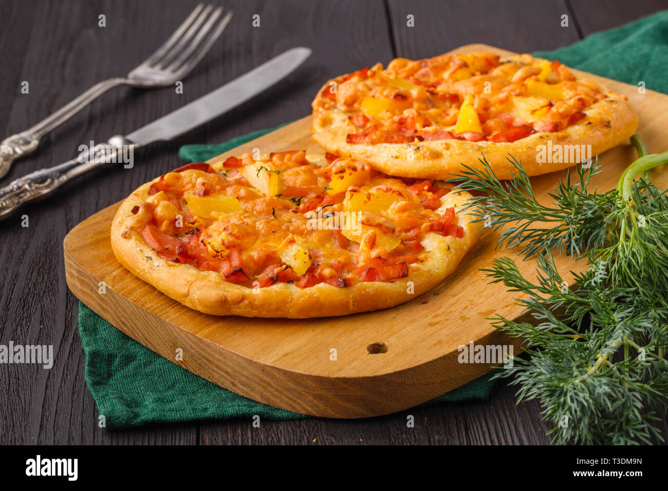 Vegetarian mini pizza on sliced board Stock Photo - Alamy