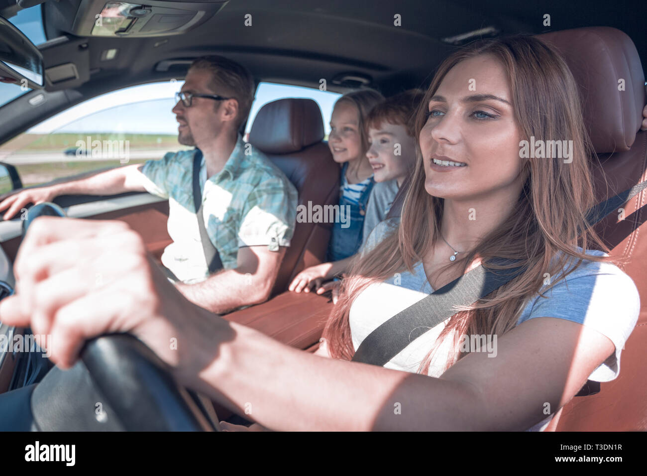 happy mom driving a family car Stock Photo - Alamy