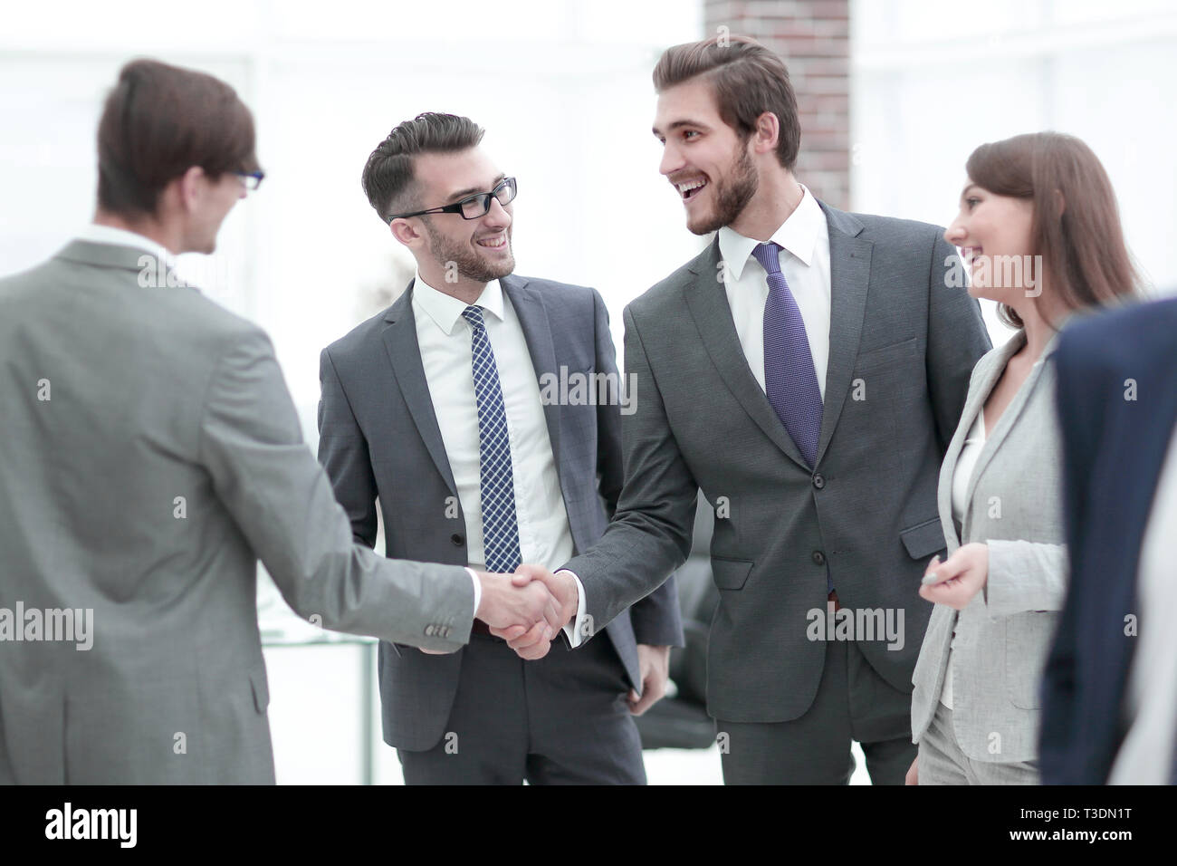 Confident young people, handshake and smile Stock Photo - Alamy