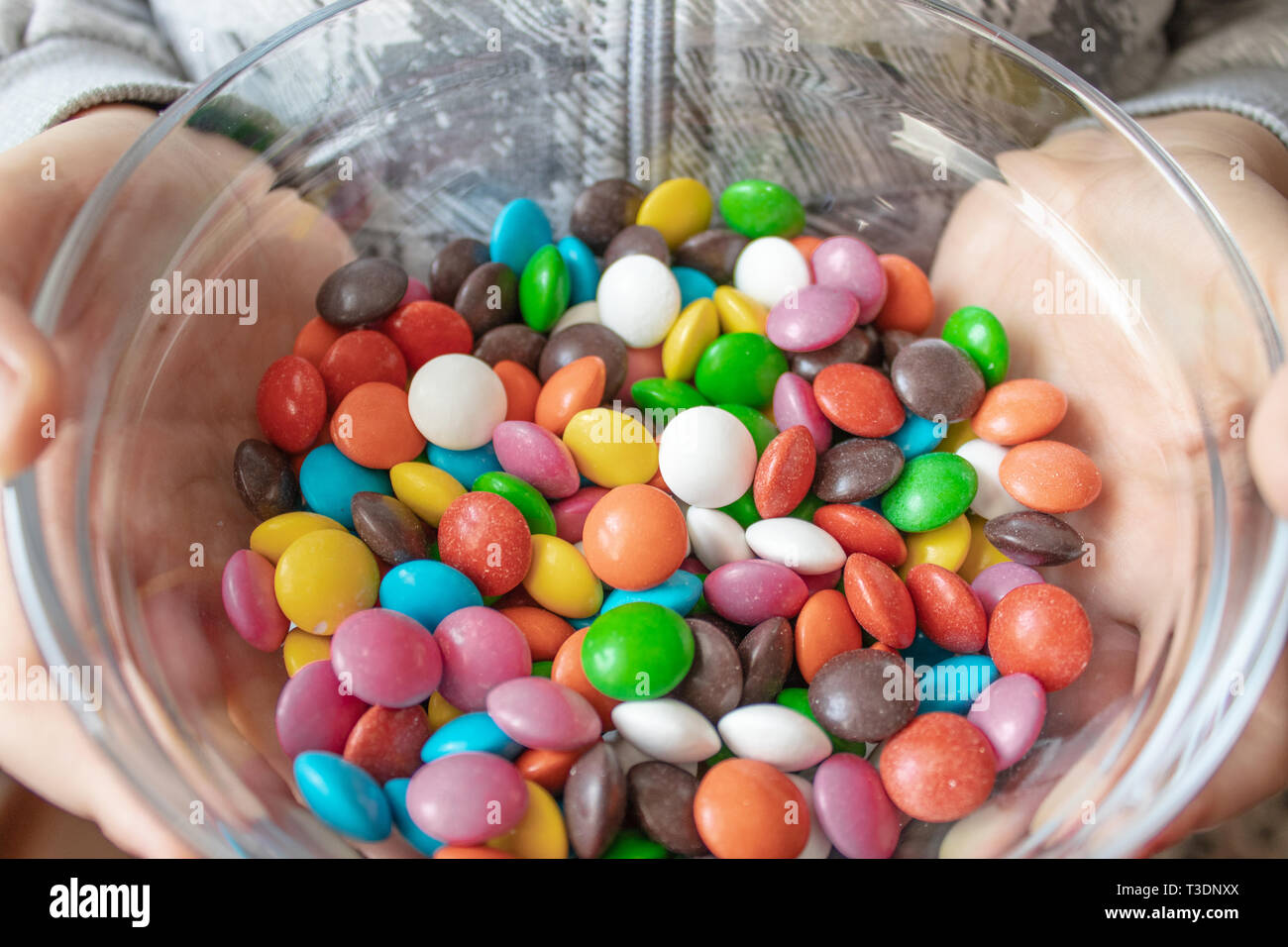Round, multi-colored candies. Candy close-up, in a glass container. The ...