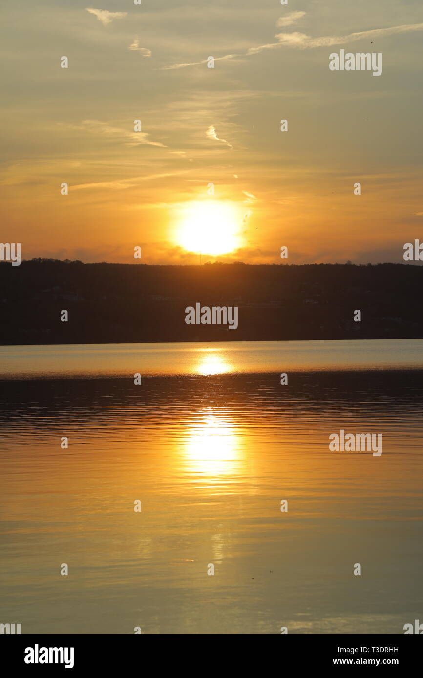 Sunset over water Stock Photo - Alamy