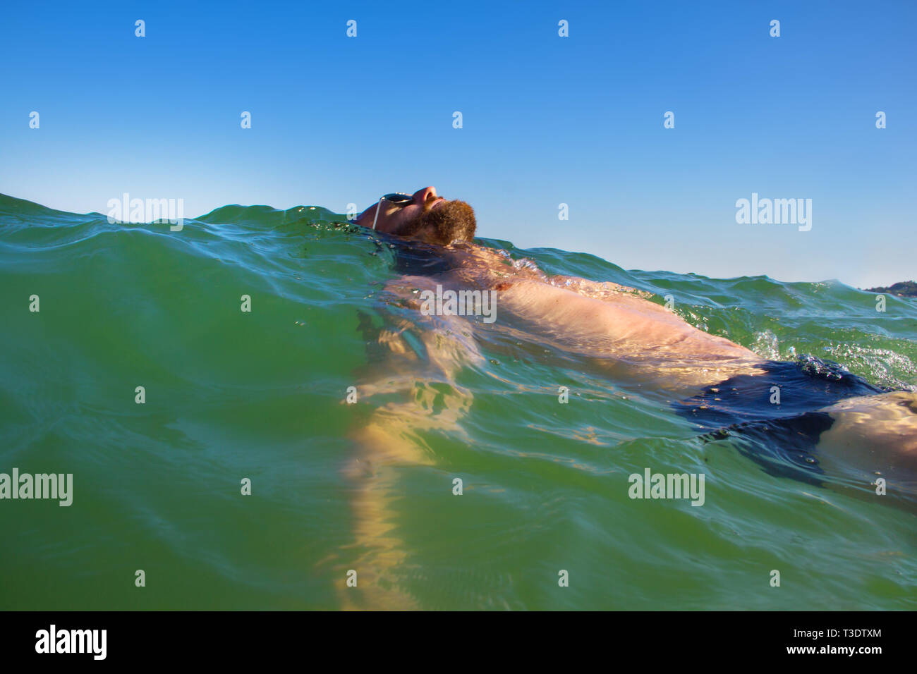 Photo of the Man floating and relax in water of Black Sea. Tourism ...