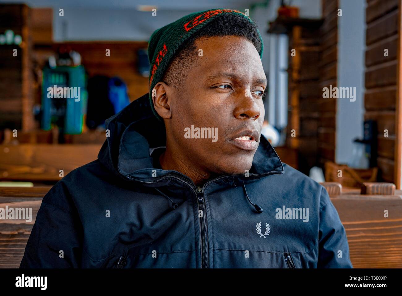 a black man looking away with a frown Stock Photo - Alamy