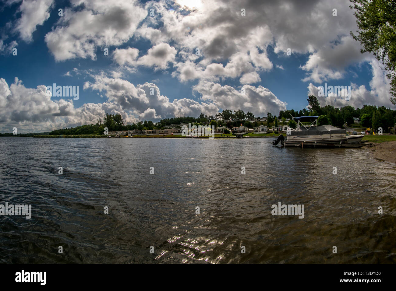 Cottage lake, pontoon boat and high contrast sky Stock Photo - Alamy