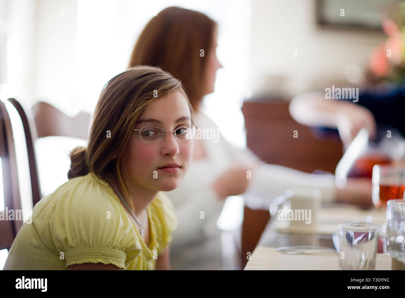 Girl at the dinner table Stock Photo - Alamy