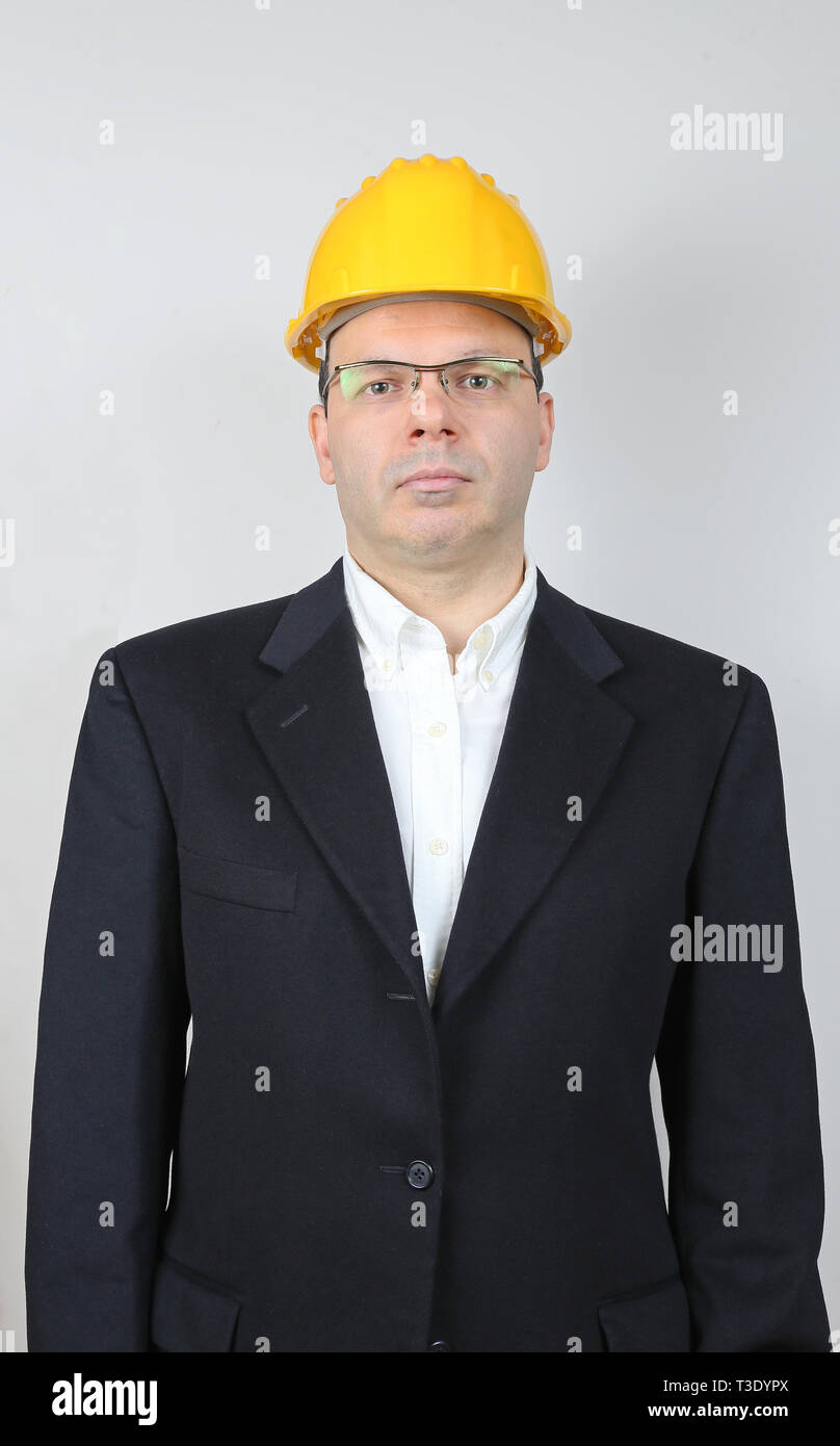 Businessman in Black Suit With Yellow Hard Hat Stock Photo - Alamy