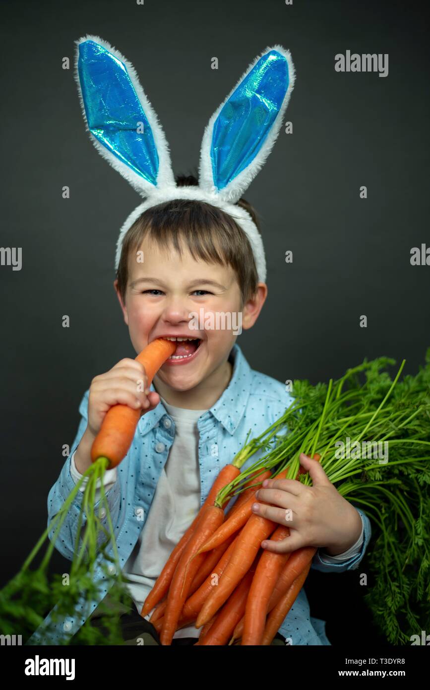 Little boy eating carrot Stock Photo - Alamy