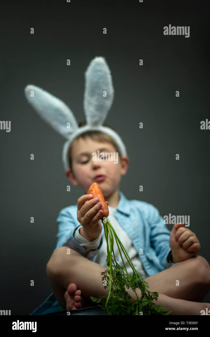 Little boy eating carrot Stock Photo - Alamy