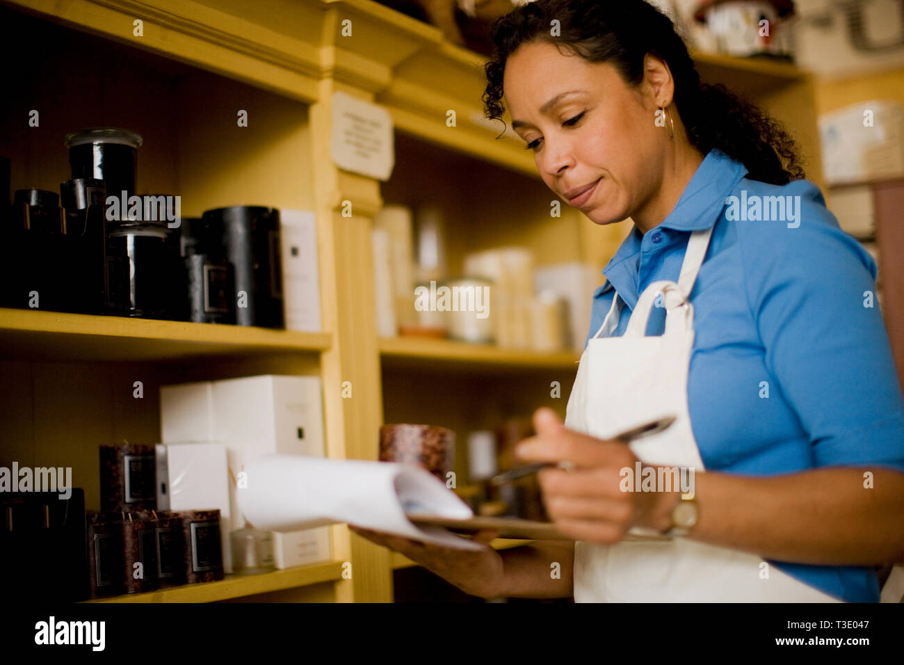 Sales clerk taking inventory in store Stock Photo - Alamy