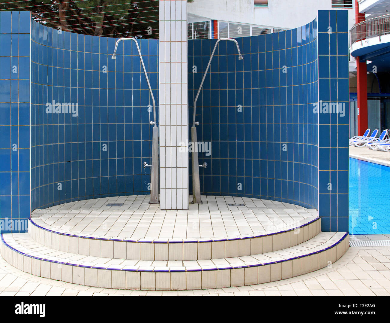 Two shower cabins behind outdoor swimmig pool Stock Photo - Alamy