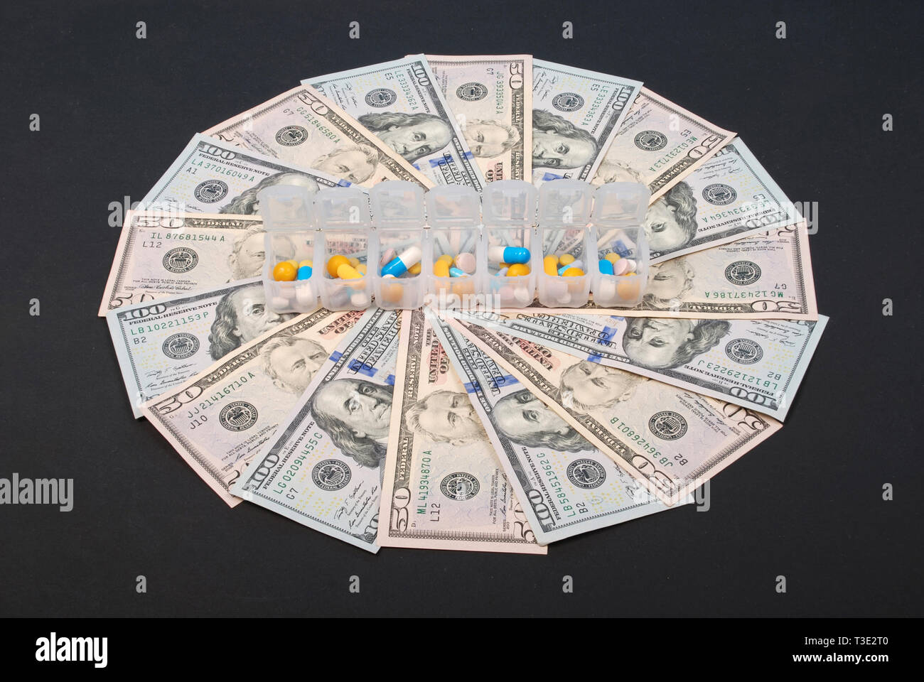 Colored capsules in open box on money, in the shape of a circle ...