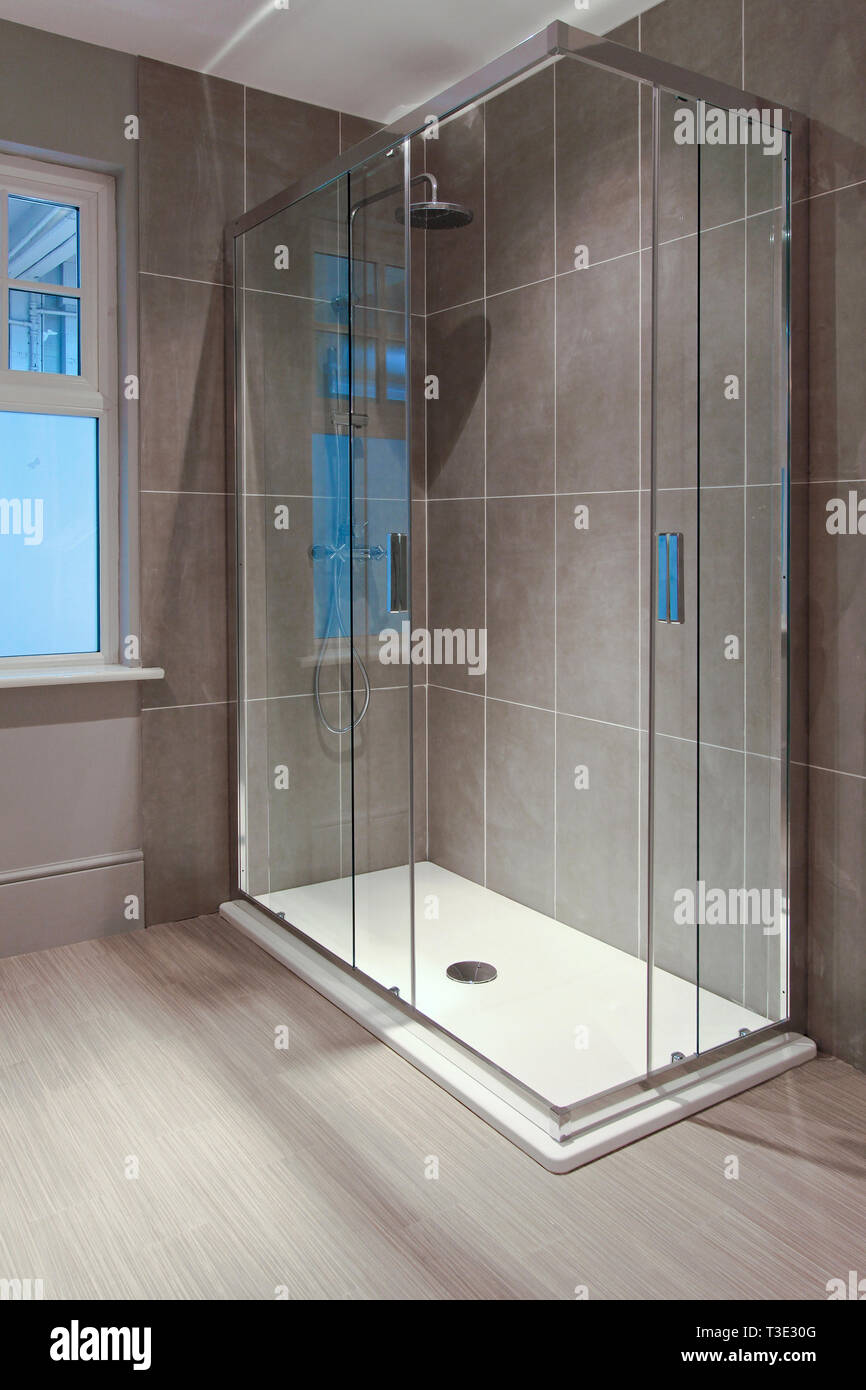 Rectangular shower with glass door in bathroom Stock Photo - Alamy