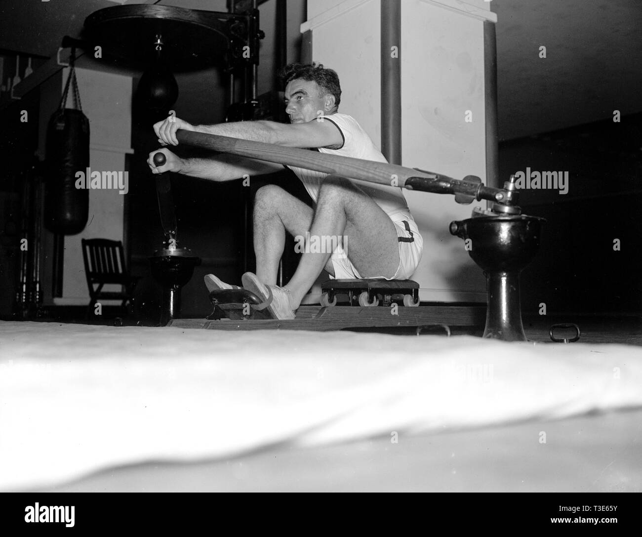 Historical Exercise - Man using a rowing machine ca. 1937 Stock Photo ...