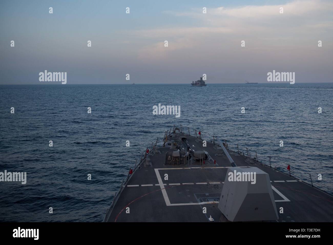 The guided-missile destroyer USS Stockdale (DDG 106), foreground ...