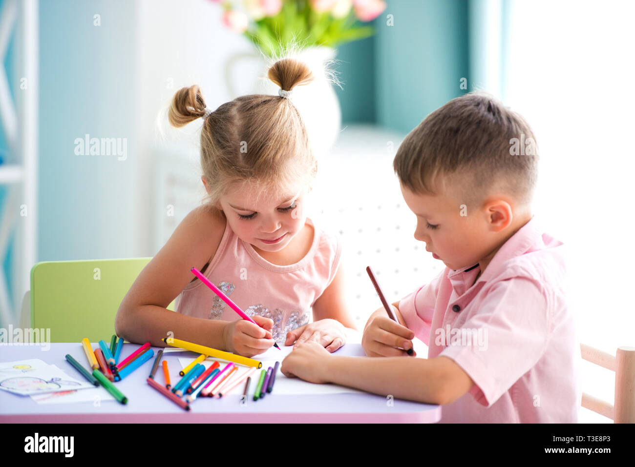 Little children play and draw with colorful pencils Stock Photo - Alamy