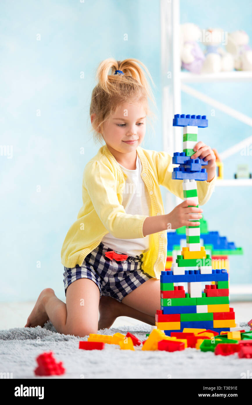the girl built a tower of cubes. The joy of games Stock Photo - Alamy