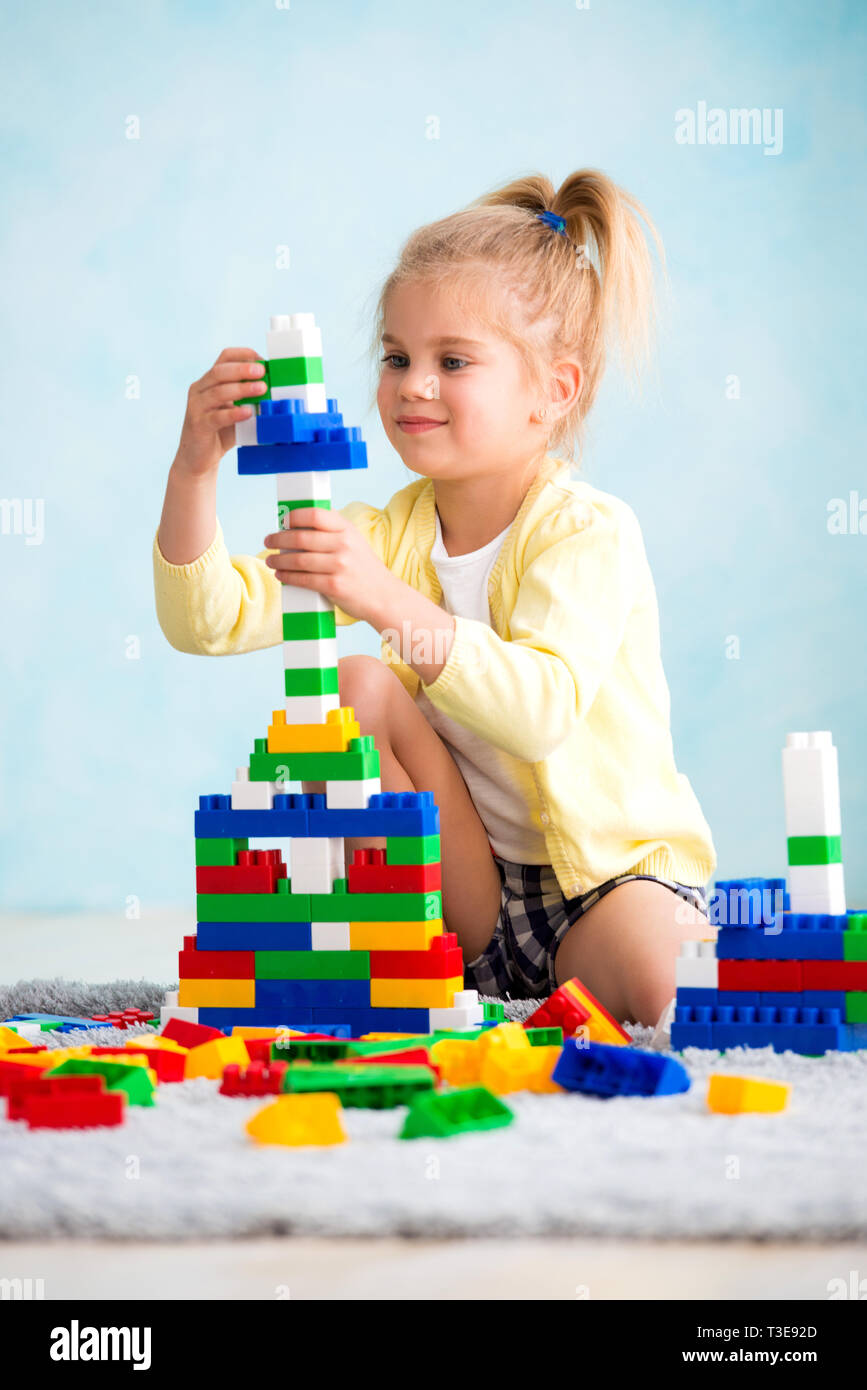 the girl built a tower of cubes. The joy of games Stock Photo - Alamy