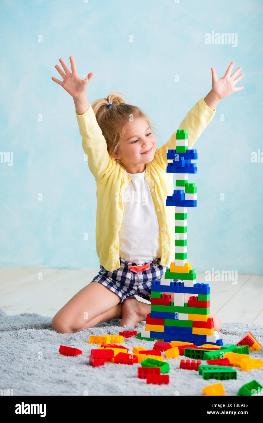 the girl built a tower of cubes. The joy of games Stock Photo - Alamy