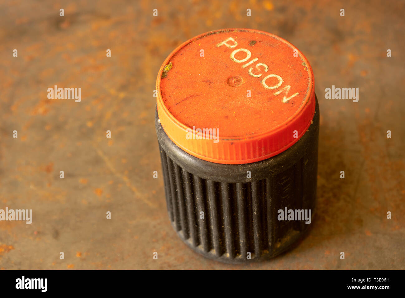 Poison black container with a red lid with the words poison Stock Photo ...
