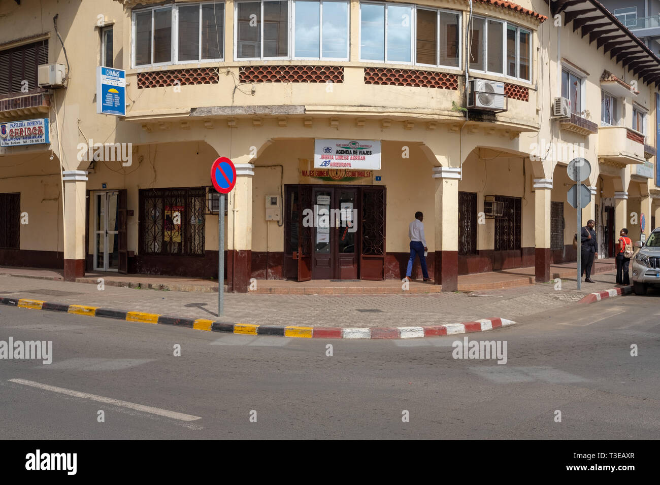 A street corner with a shop displaying a sign for Iberia, the airline ...