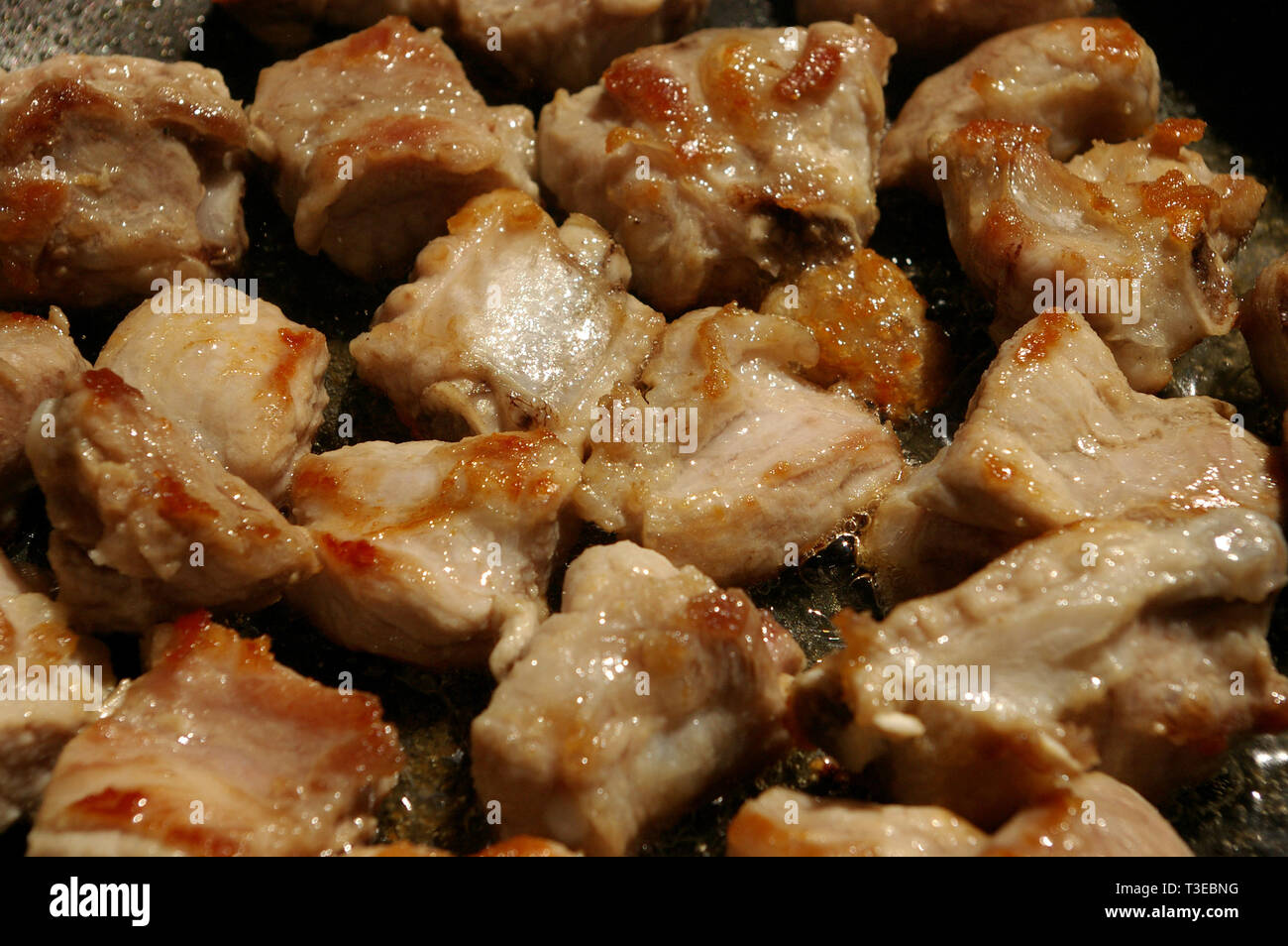 Cooking Pork bone fried in a pan with garlic Stock Photo - Alamy