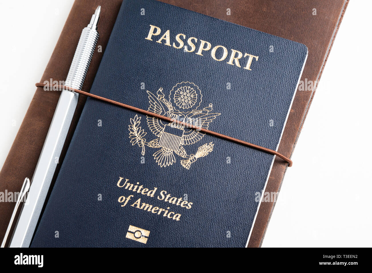 An American passport strapped to a leather-bound travel journal and a ...