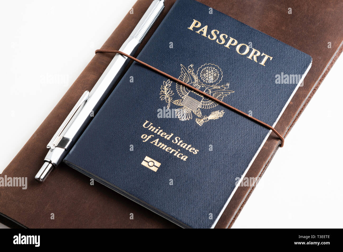 An American passport strapped to a leather-bound travel journal and a ...