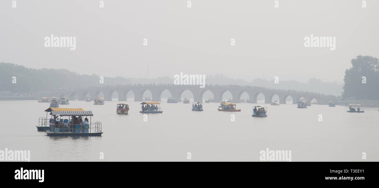 A very long bridge with multiple arches in the haze across a Chinese ...