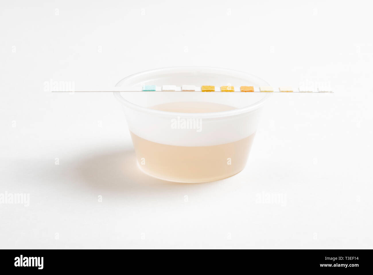 A combination of urine sample on a small round plastic container and a ...
