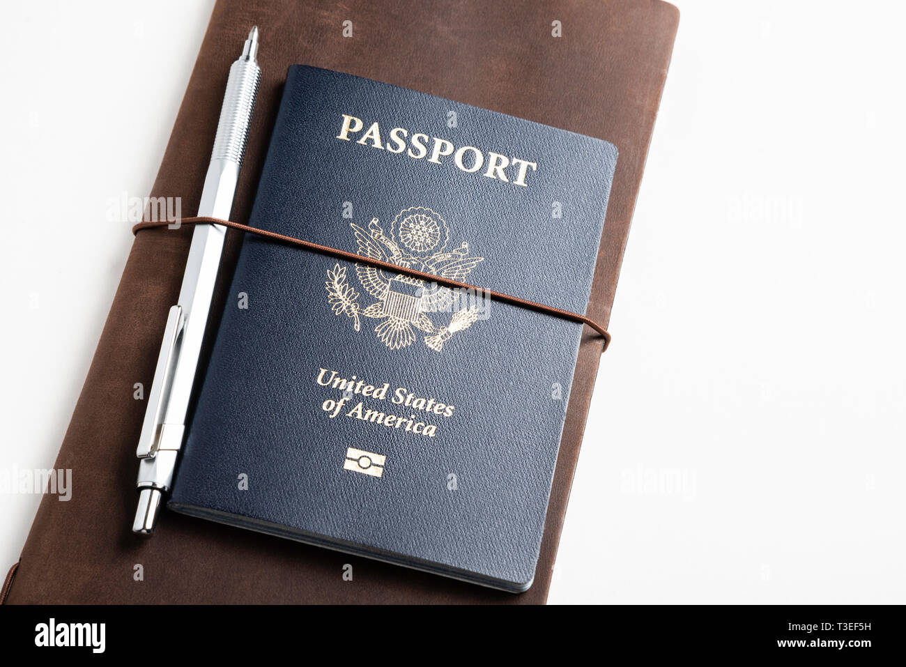 An American passport strapped to a leather-bound travel journal and a ...