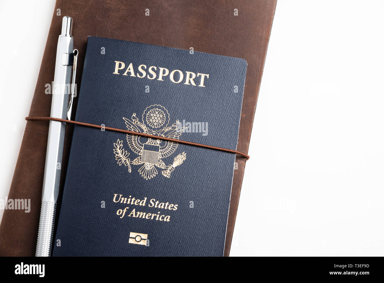 An American passport strapped to a leather-bound travel journal and a ...