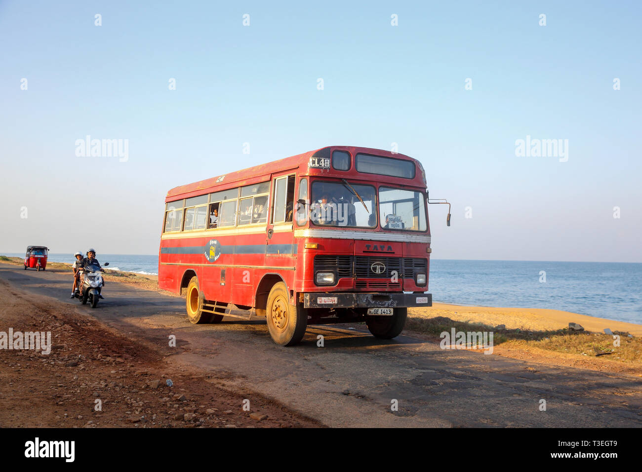 A passenger bus crossing the marine drive road at Chilaw in Srilanka ...