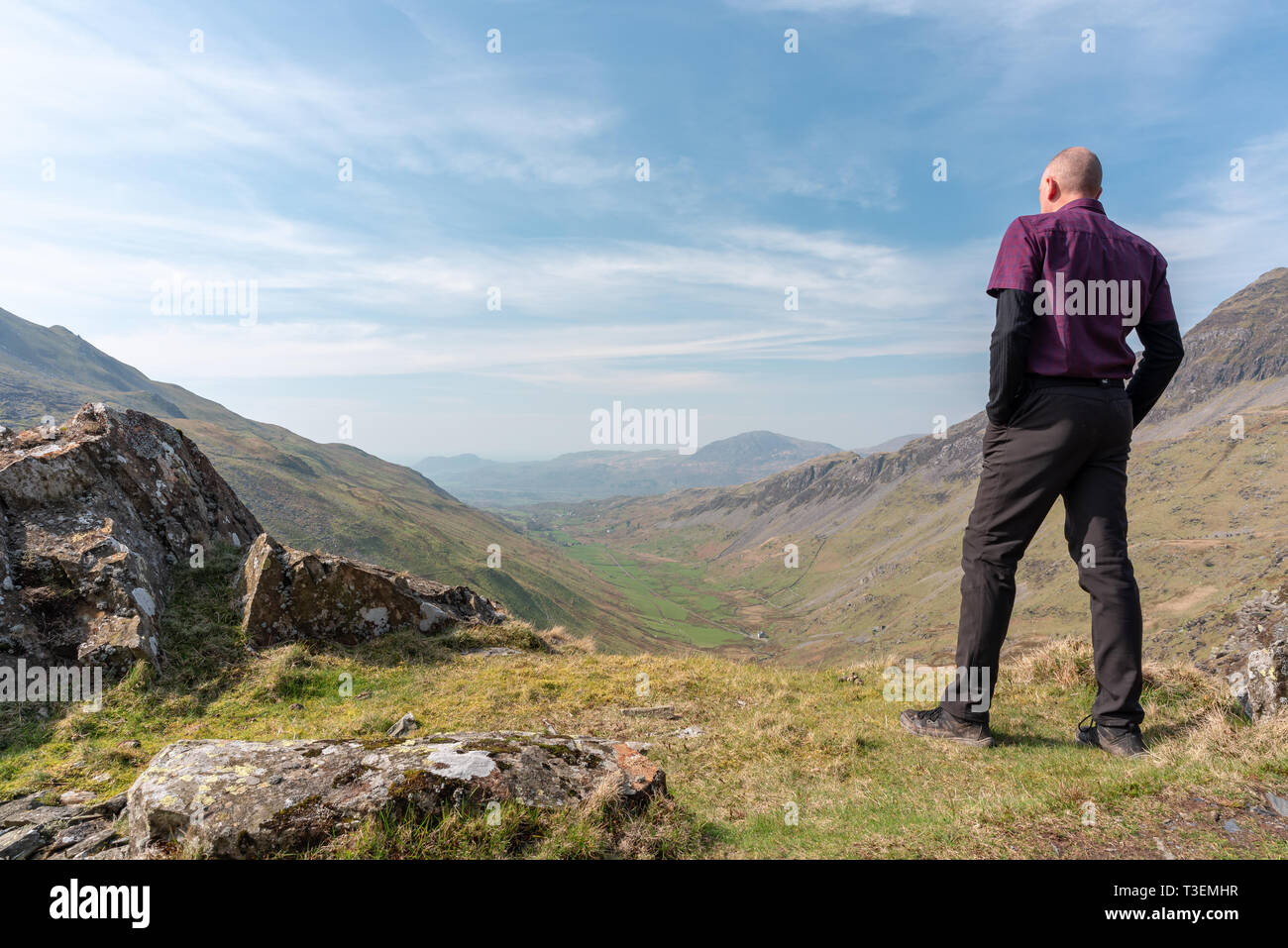 A walker admiring the view of Cwm Croesor from Cnicht, Gwynedd, Wales ...