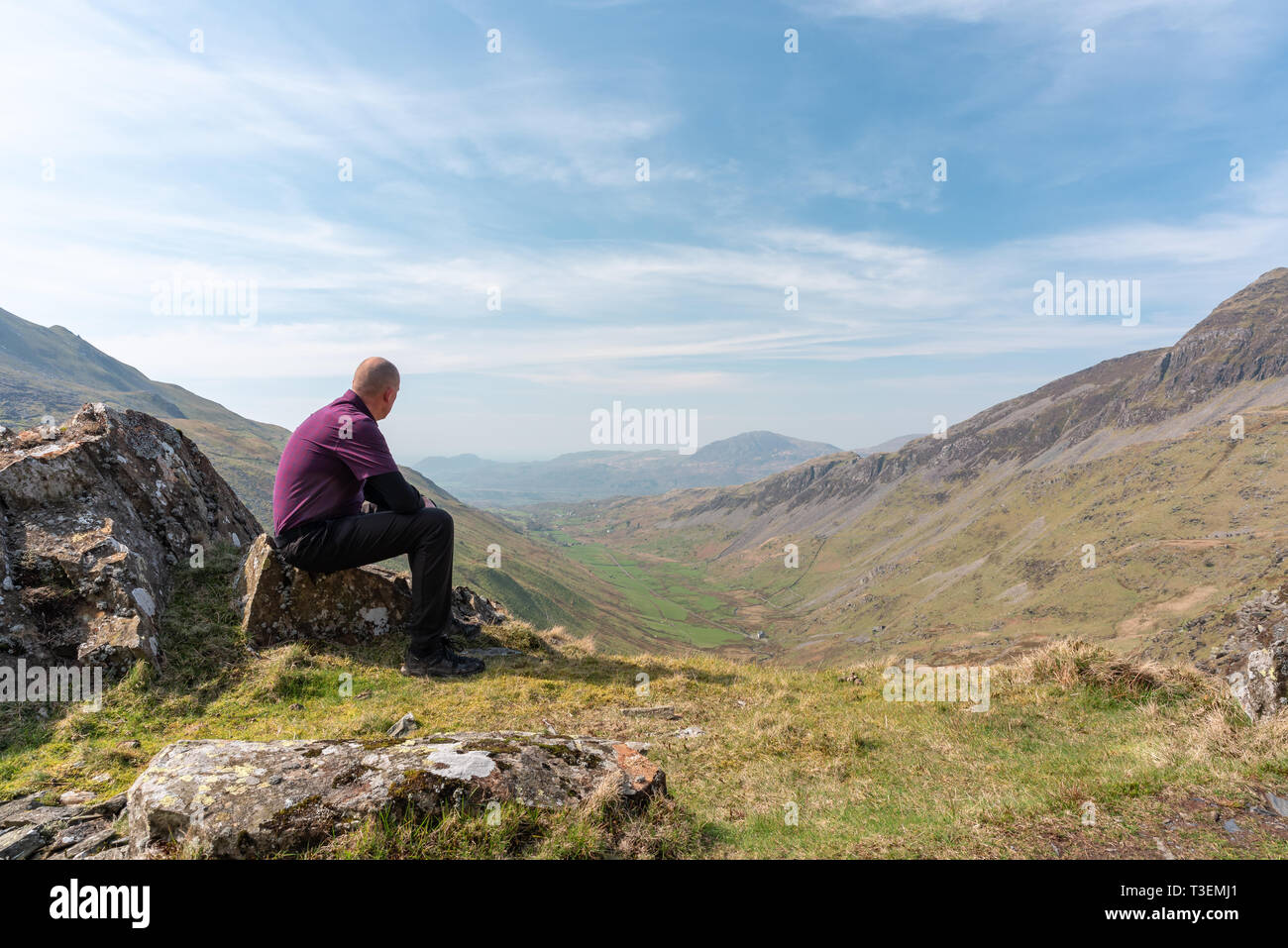 A walker admiring the view of Cwm Croesor from Cnicht, Gwynedd, Wales ...