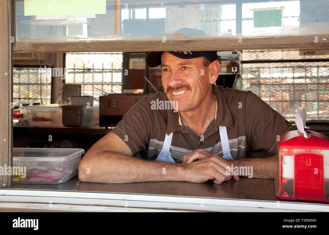 Happy, smiling hispanic latino man working service industry blue collar ...