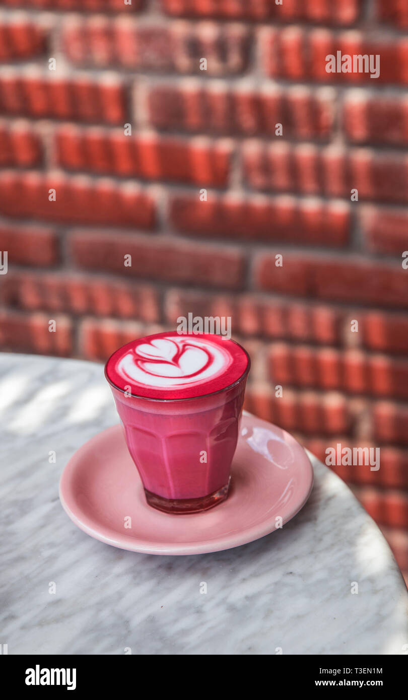 Pink Beetroot super latte on marble background closed to brick wall ...