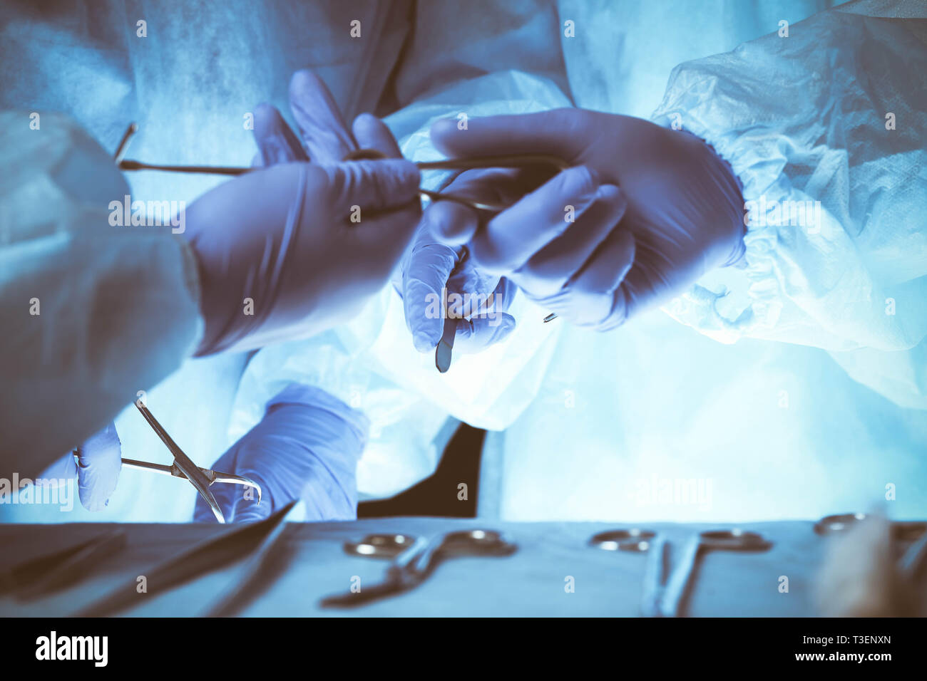 Surgeons hands holding surgical scissors and passing surgical equipment ...
