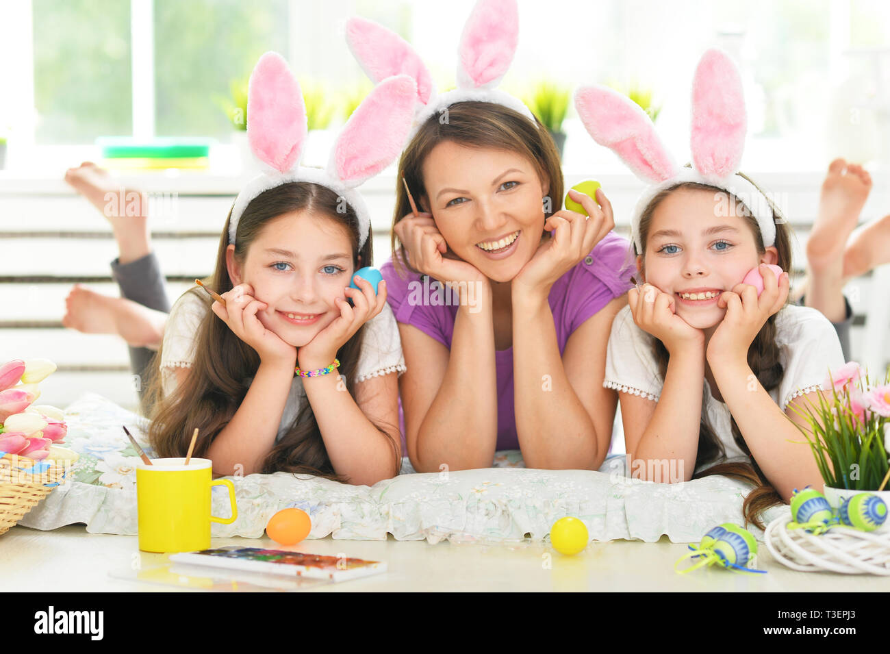 Cute twins with mother wearing rabbit ears Stock Photo - Alamy
