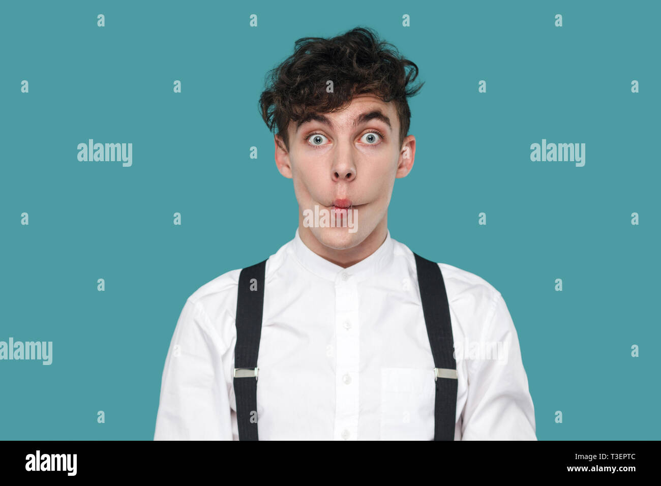 Funny surprised man with fish lips, big eyes looking at camera ...